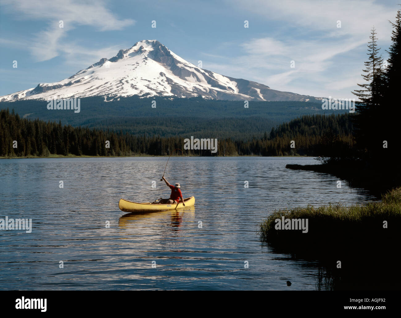 Canoe fishing at Trillium Lake in Oregon with Mount Hood in the ...