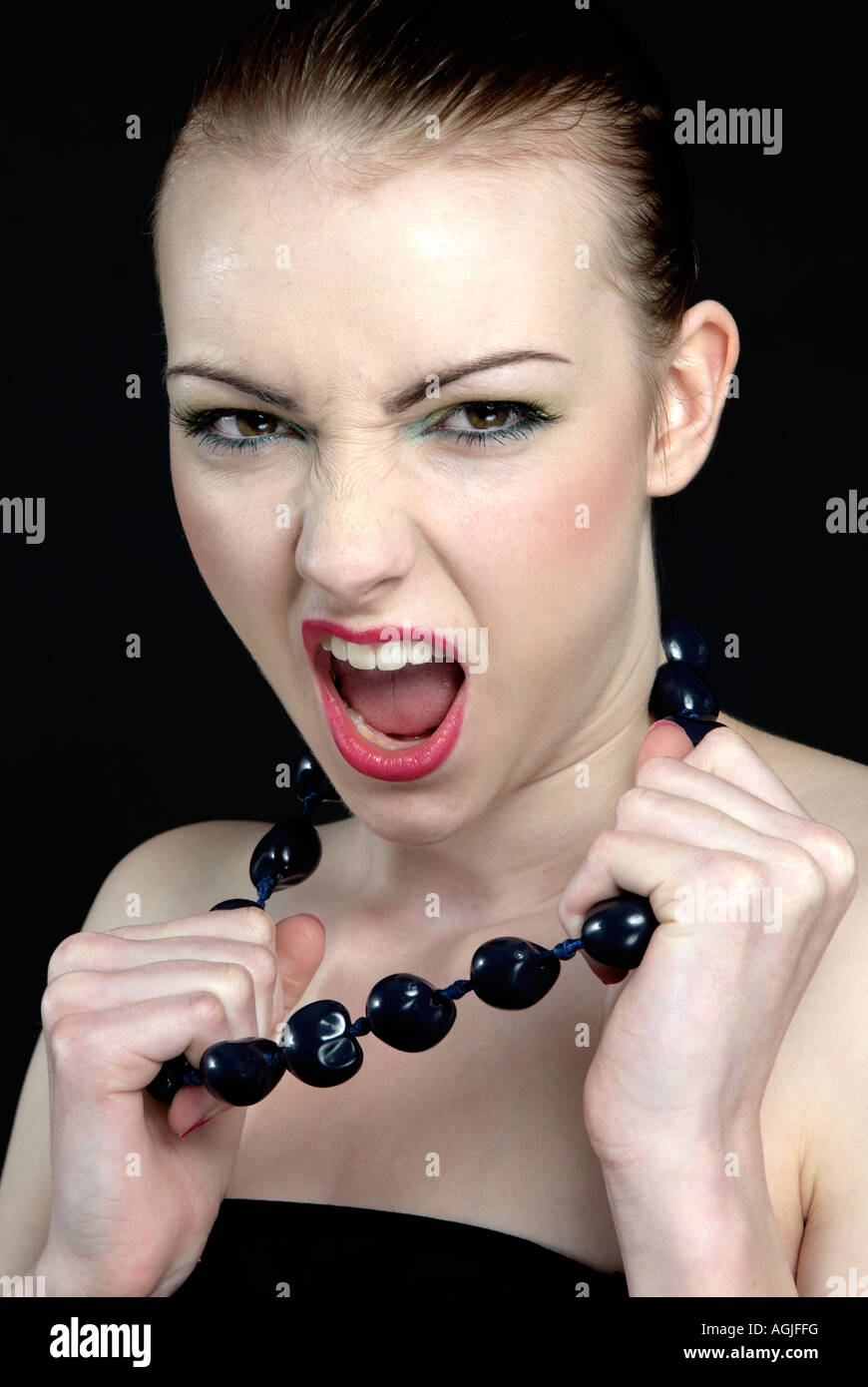 frustration woman shouting and pulling on necklace Stock Photo - Alamy