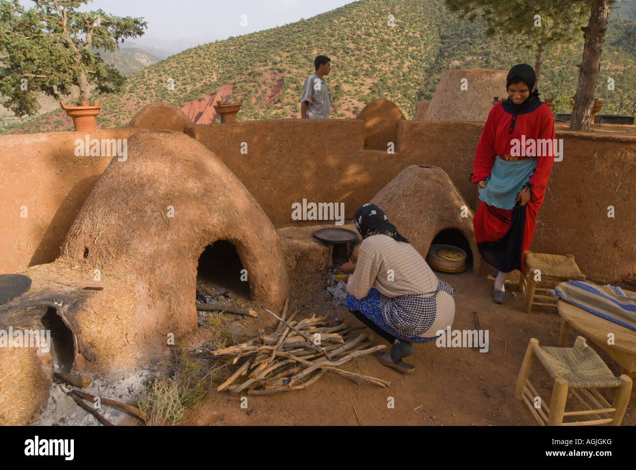 Traditional Berber mud bread ovens tended by women in traditional local ...