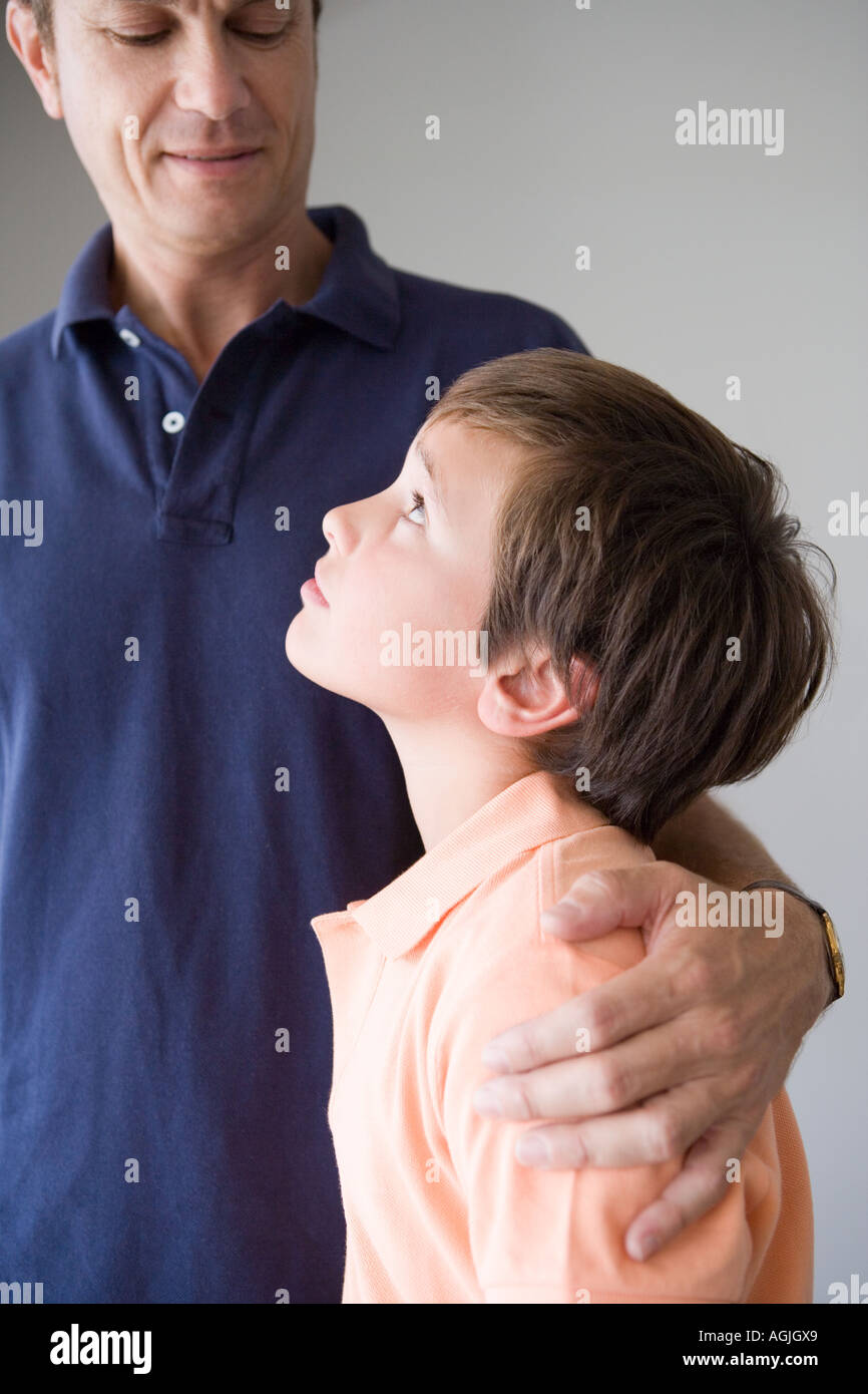 Son looking up to father Stock Photo - Alamy