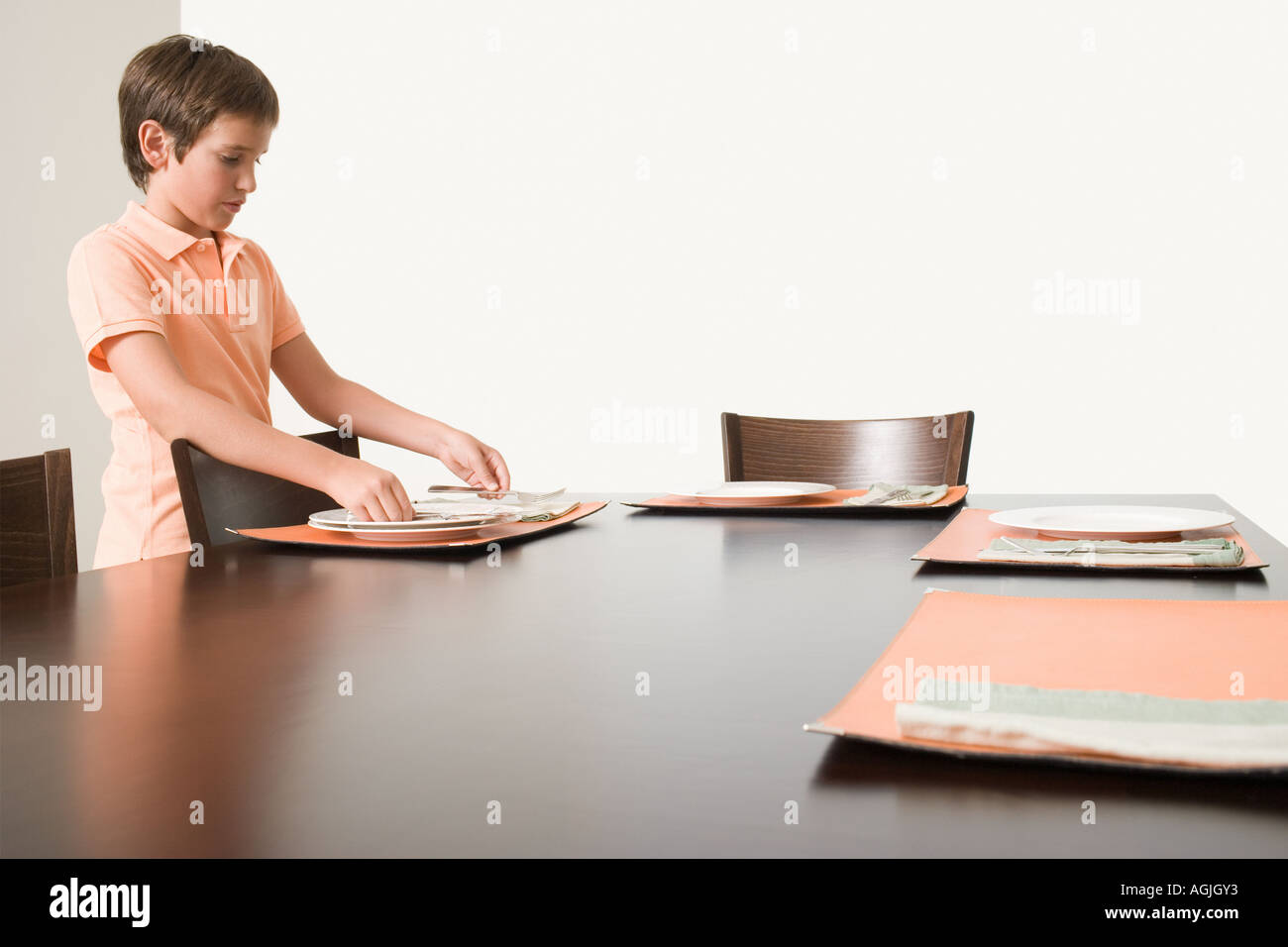 Boy setting the table Stock Photo - Alamy