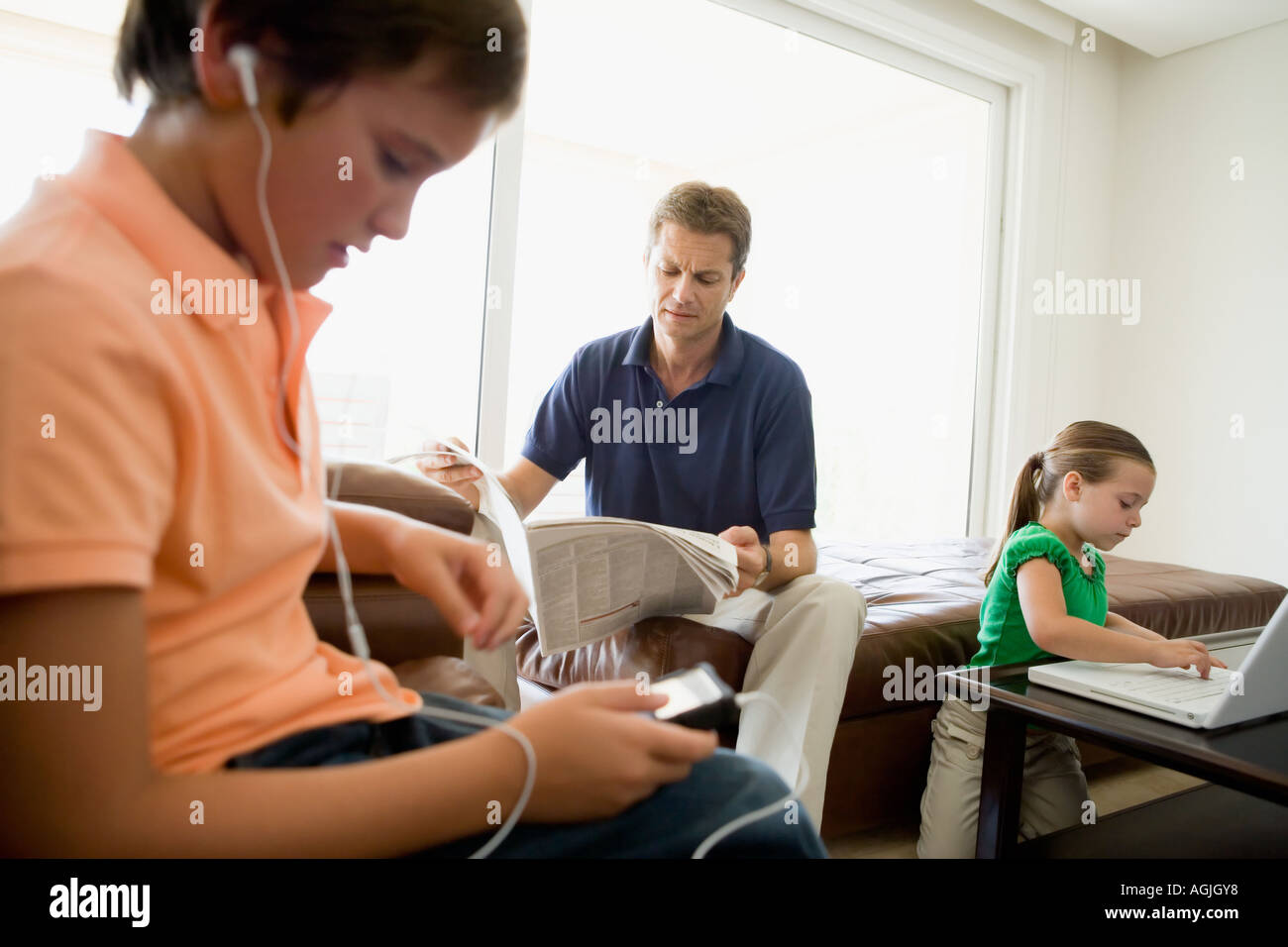 Family doing separate activities Stock Photo - Alamy