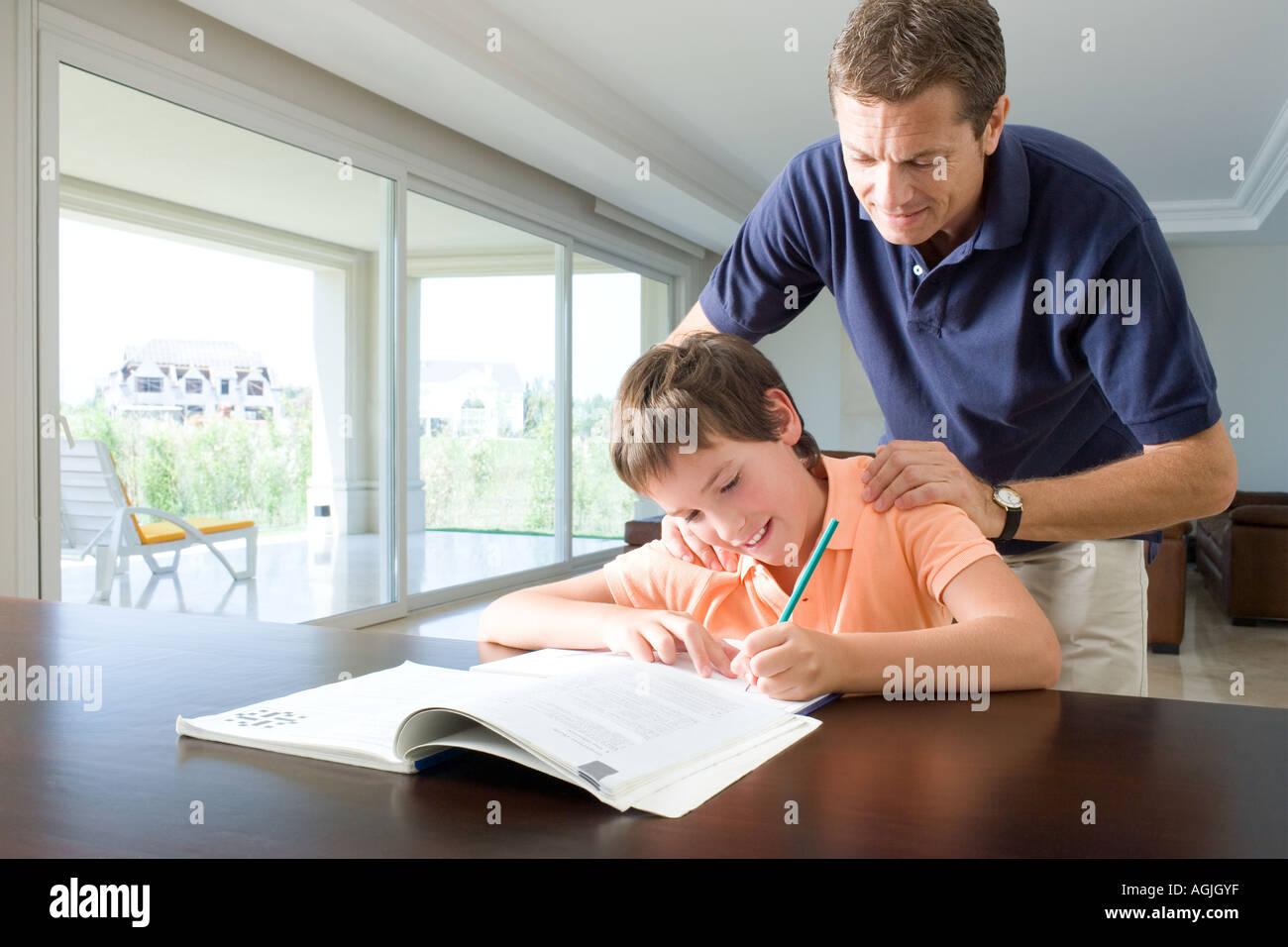 Father supervising son hi-res stock photography and images - Alamy