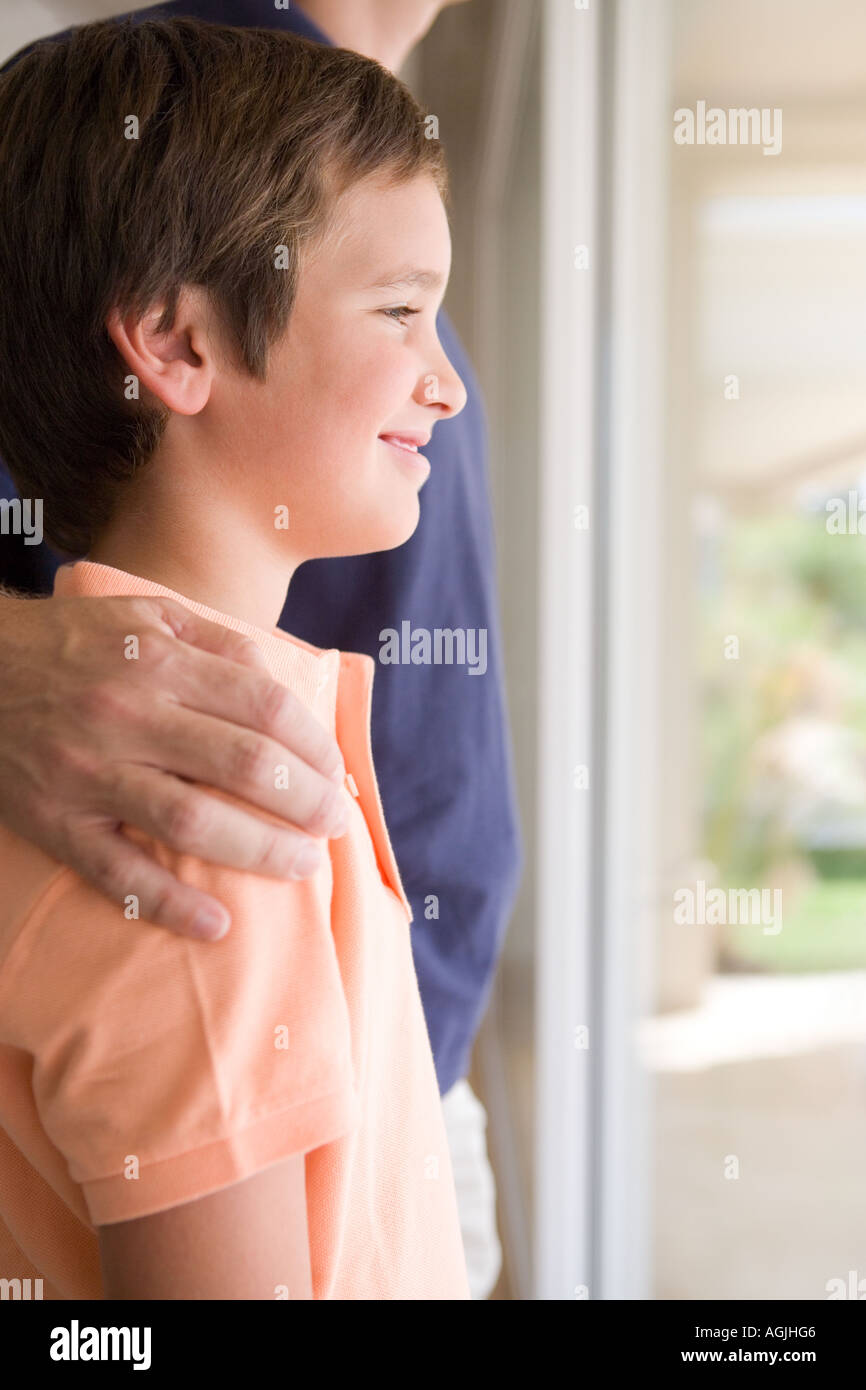 Boy with father's hand on his shoulder Stock Photo - Alamy