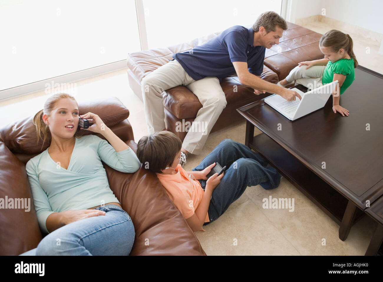 Family using different technology hi-res stock photography and images ...