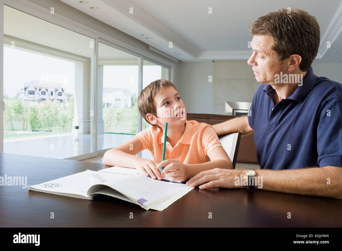 Father helping son with homework Stock Photo - Alamy