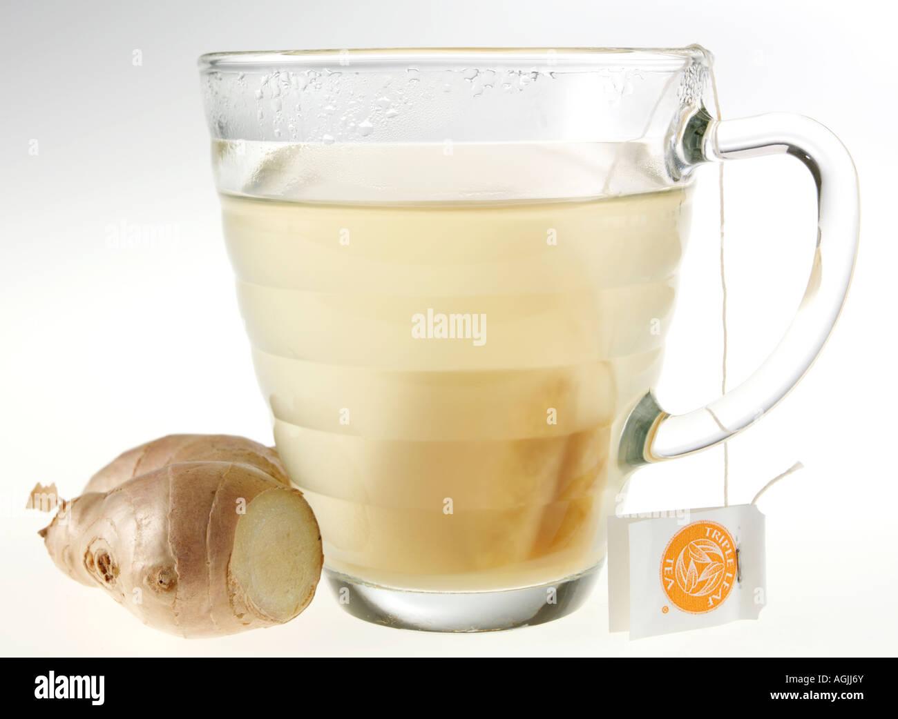 A glass mug of ginger tea on a white background Stock Photo - Alamy