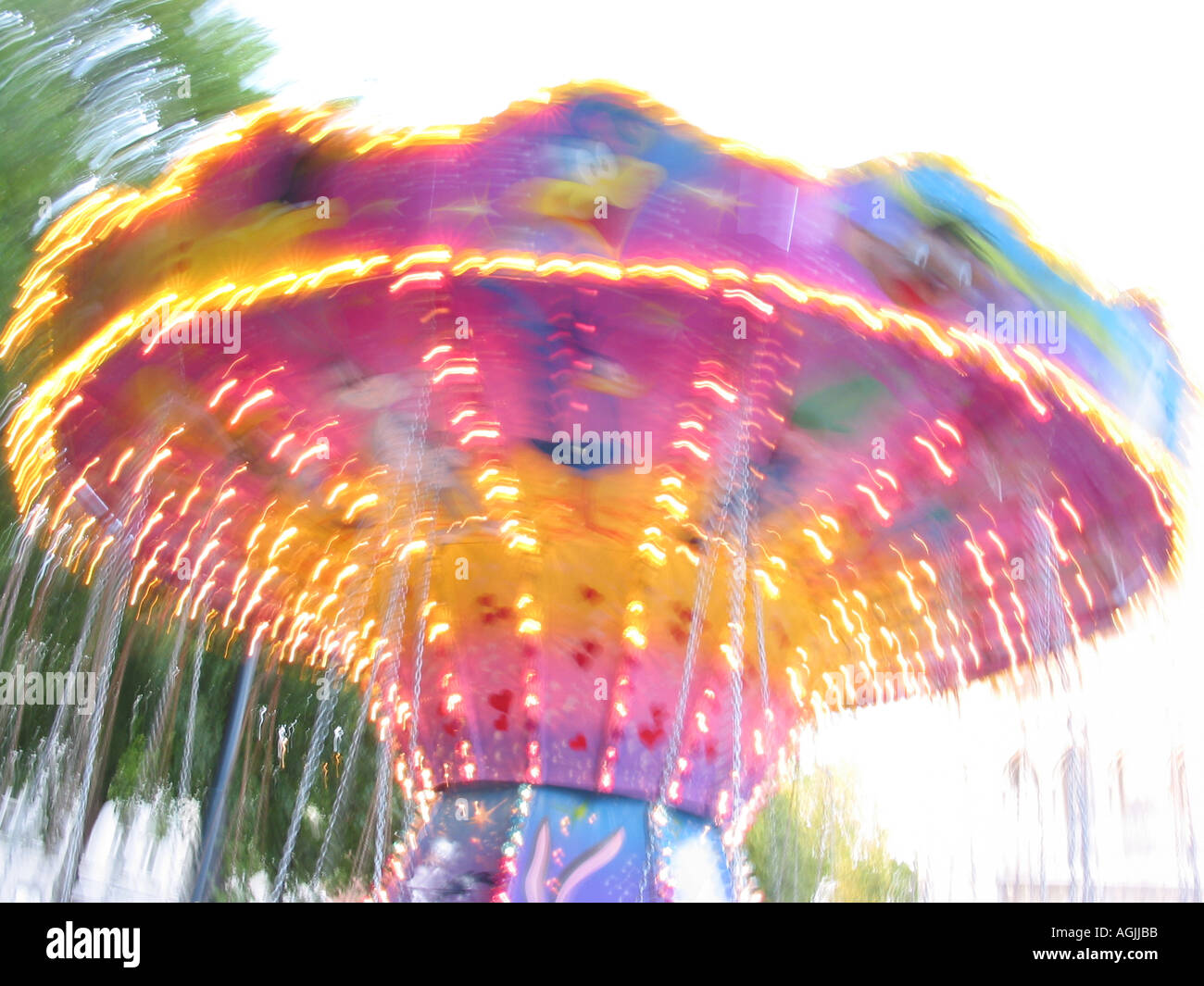 high key image of fairground carousel in full swing Stock Photo - Alamy