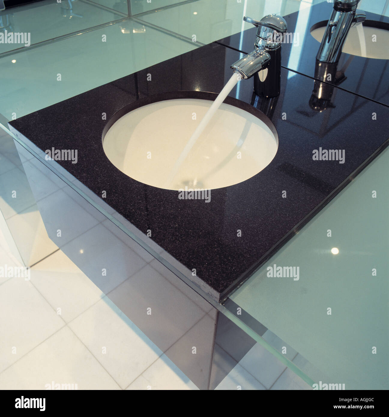 Bathroom basin with running water Stock Photo - Alamy