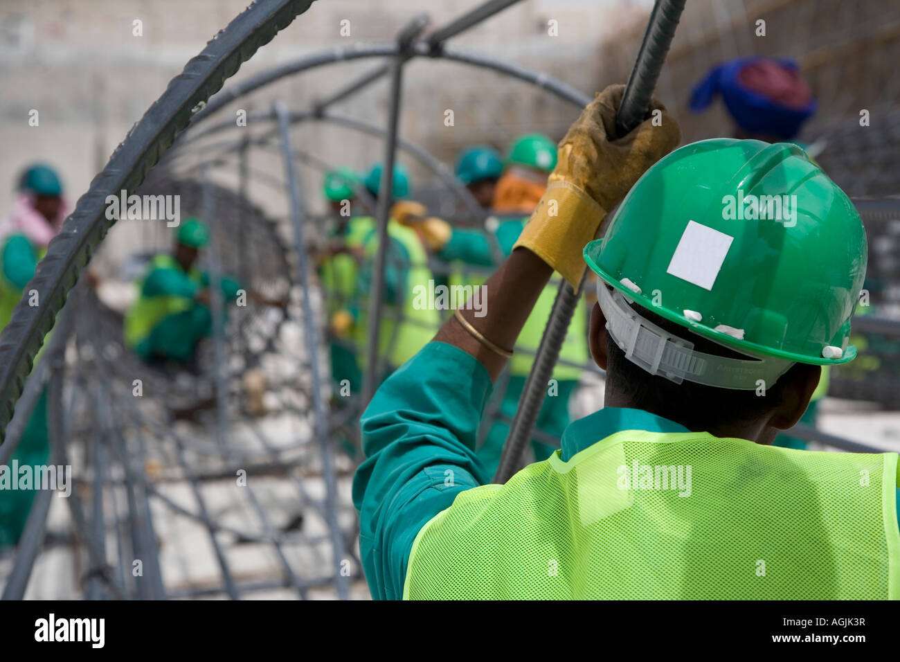 workers preparing rebar circular cage frame for reinforced concrete ...