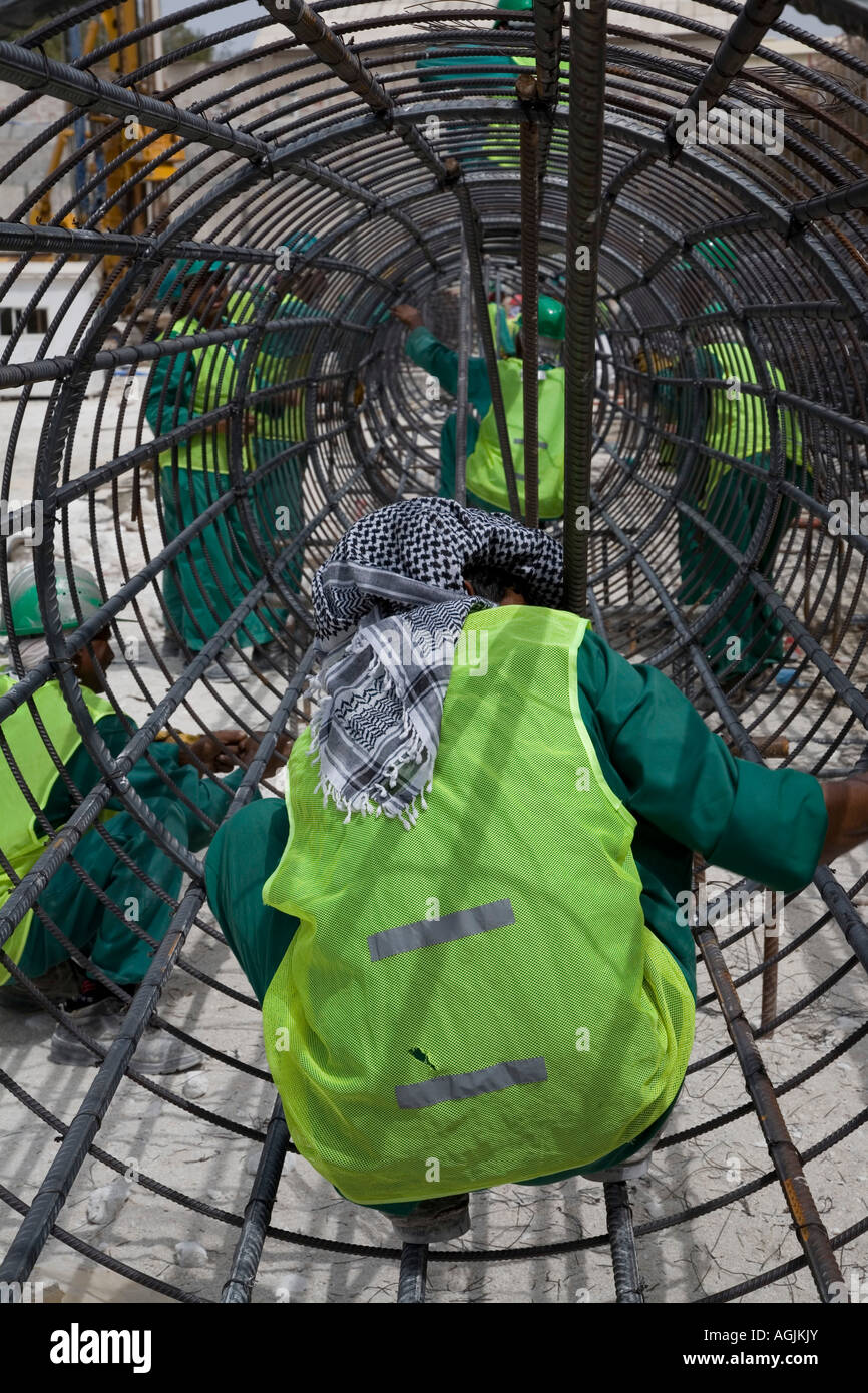 workers preparing rebar circular cage frame for reinforced concrete ...