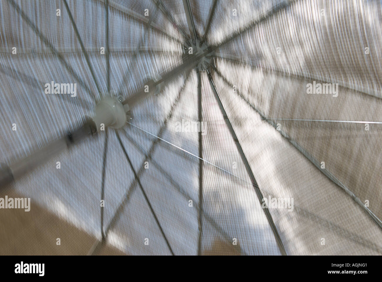 Translucent sun umbrella with sky and clouds showing through taken with ...