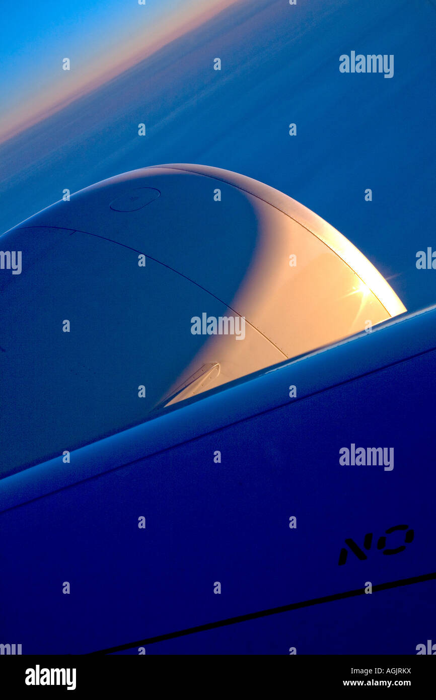 graphic shot of airplane wing and engine taken at sunrise Stock Photo ...