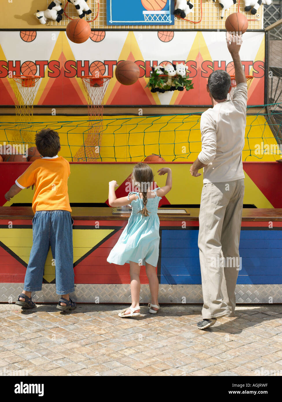 Family playing on fairground stall Stock Photo - Alamy