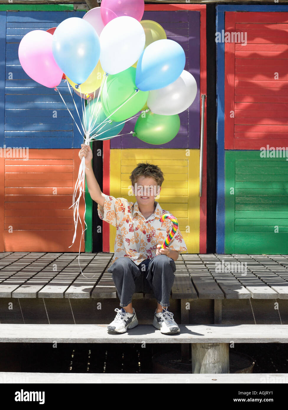 Boy on step with balloons Stock Photo - Alamy