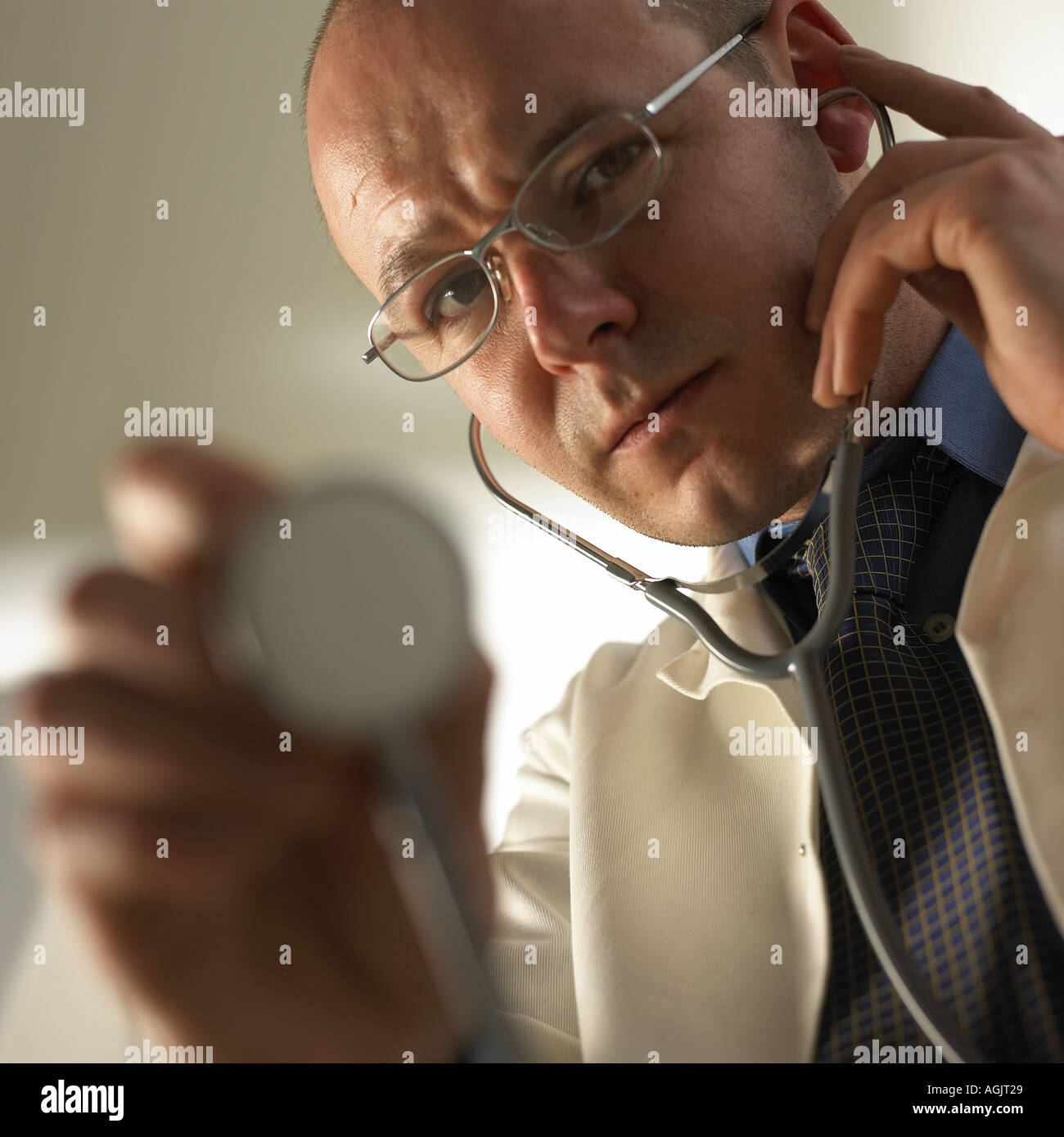 Doctor using stethoscope Stock Photo - Alamy