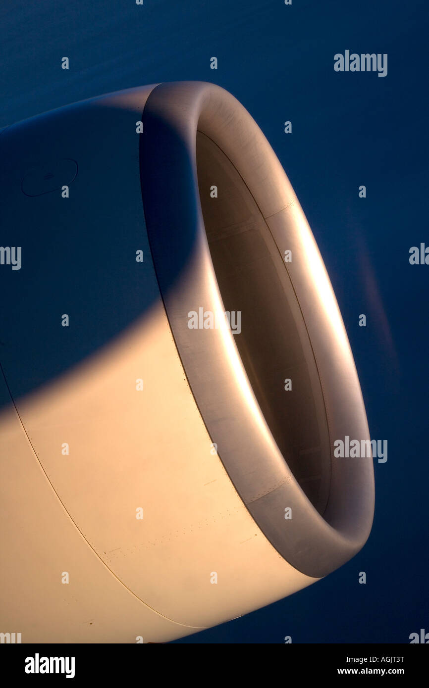 graphic shot of airplane wing and engine taken at sunrise Stock Photo ...