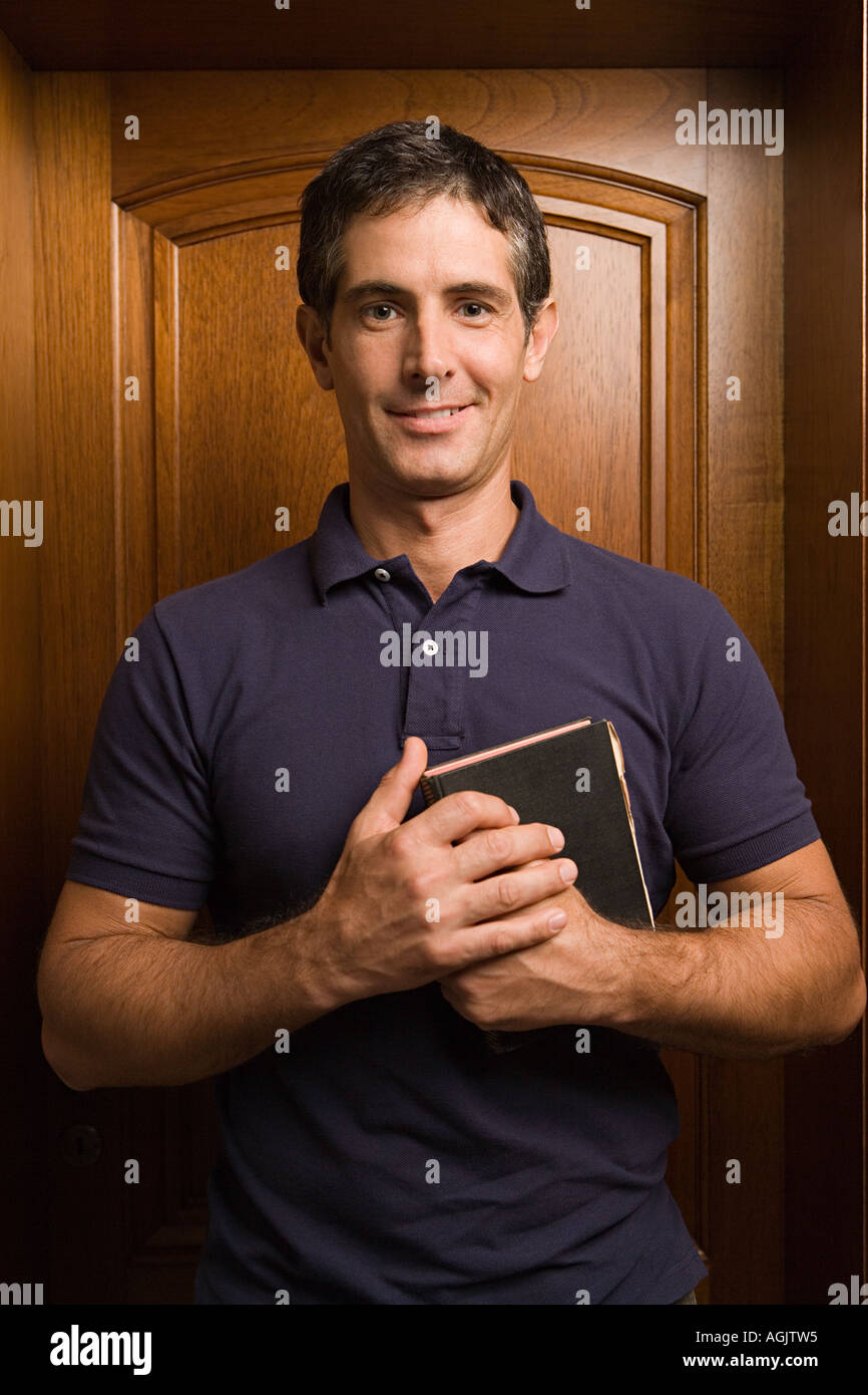 Smiling man holding bible hi-res stock photography and images - Alamy