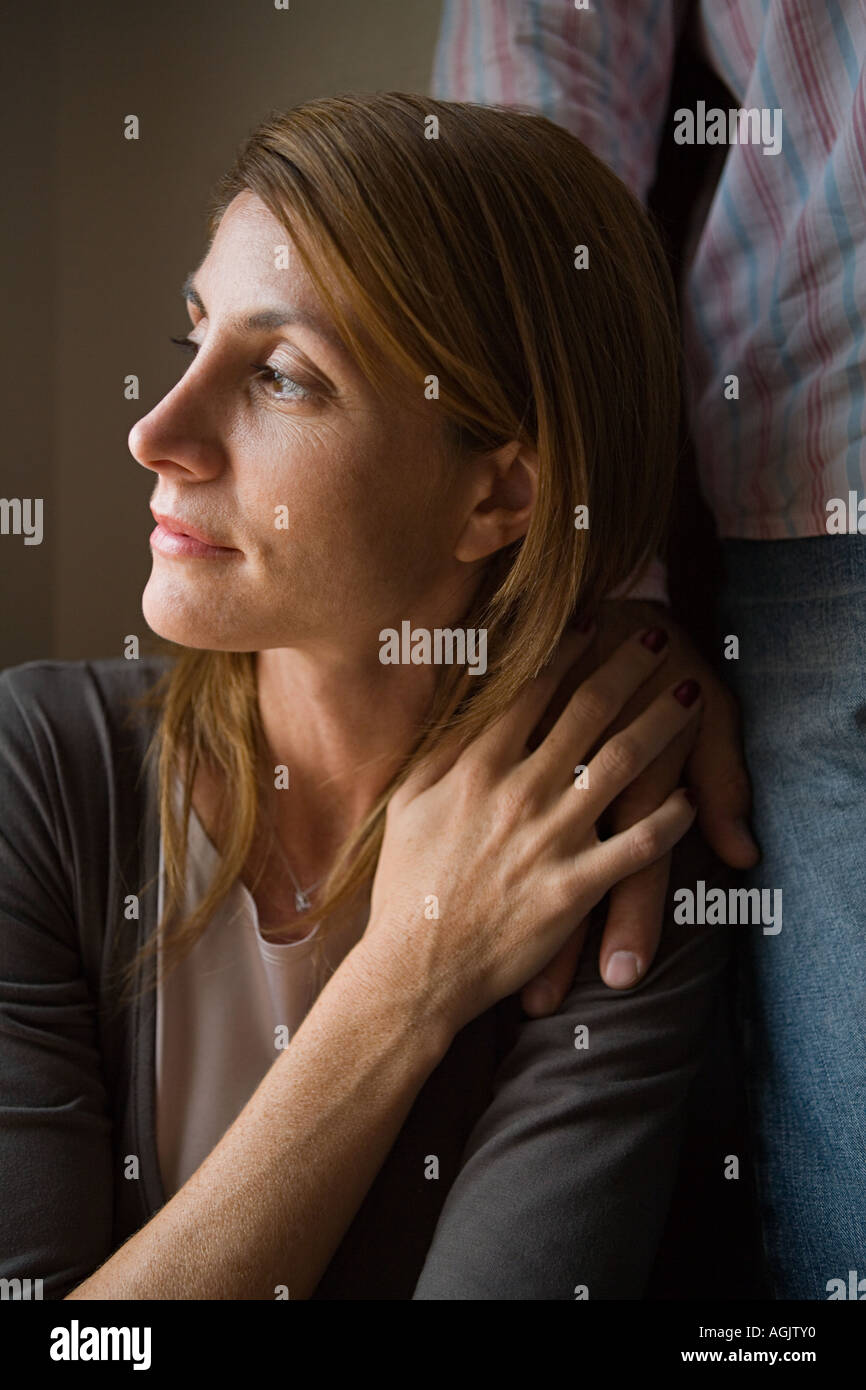 Woman touching mans shoulder hi-res stock photography and images - Alamy