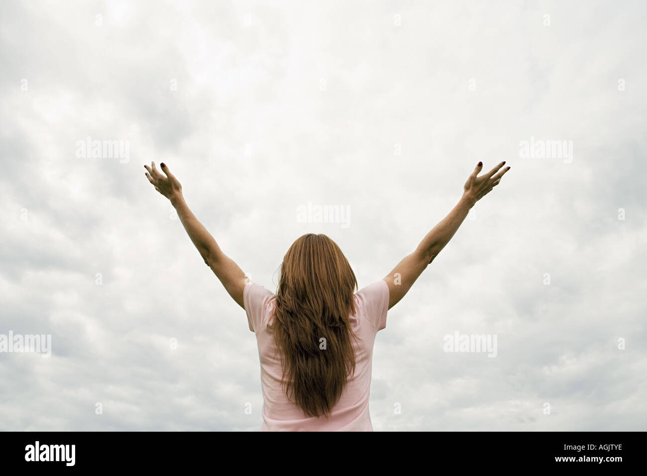 Woman worshipping with open arms Stock Photo - Alamy