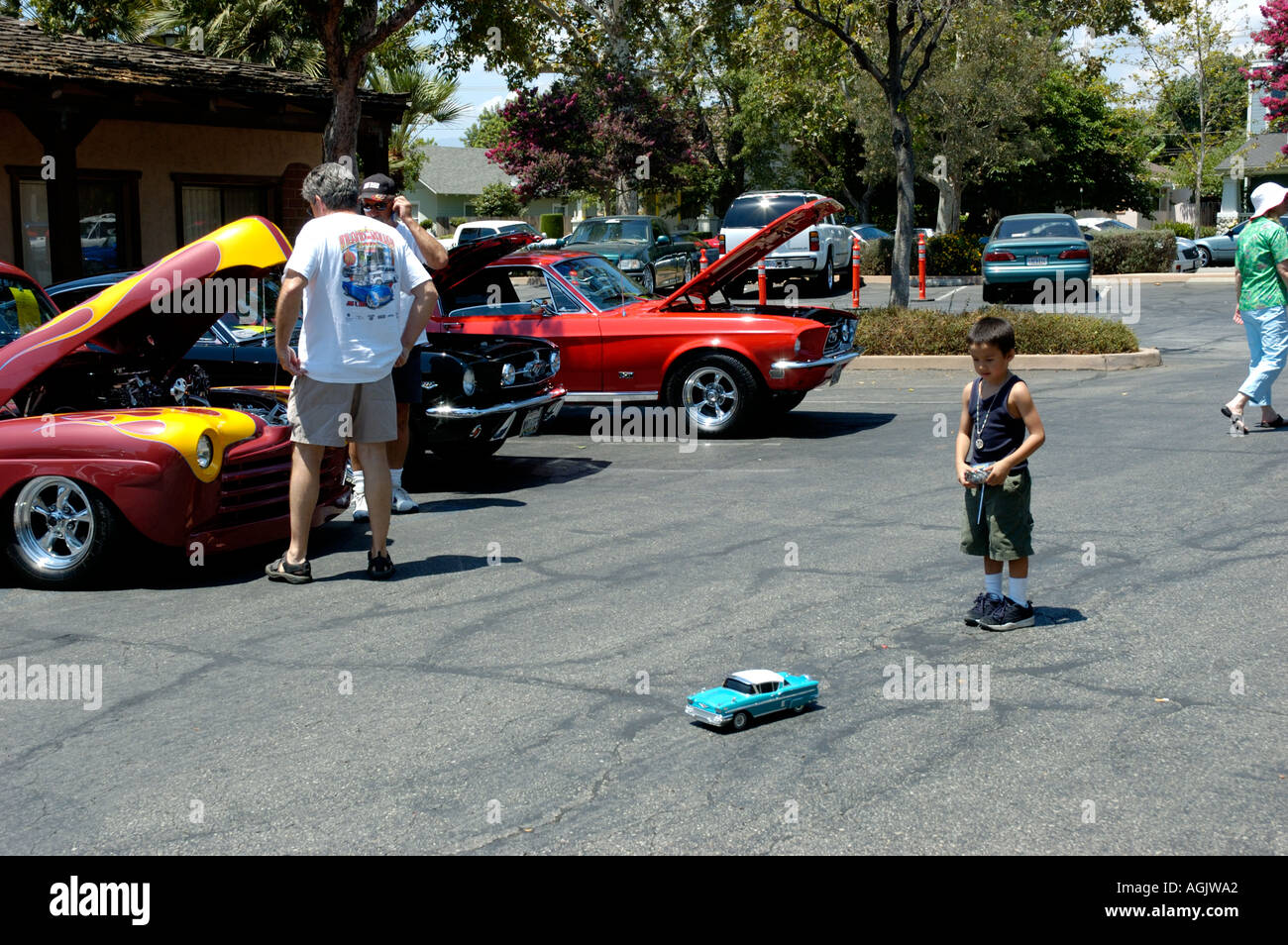 Boy playing with remote control car at car show Stock Photo - Alamy