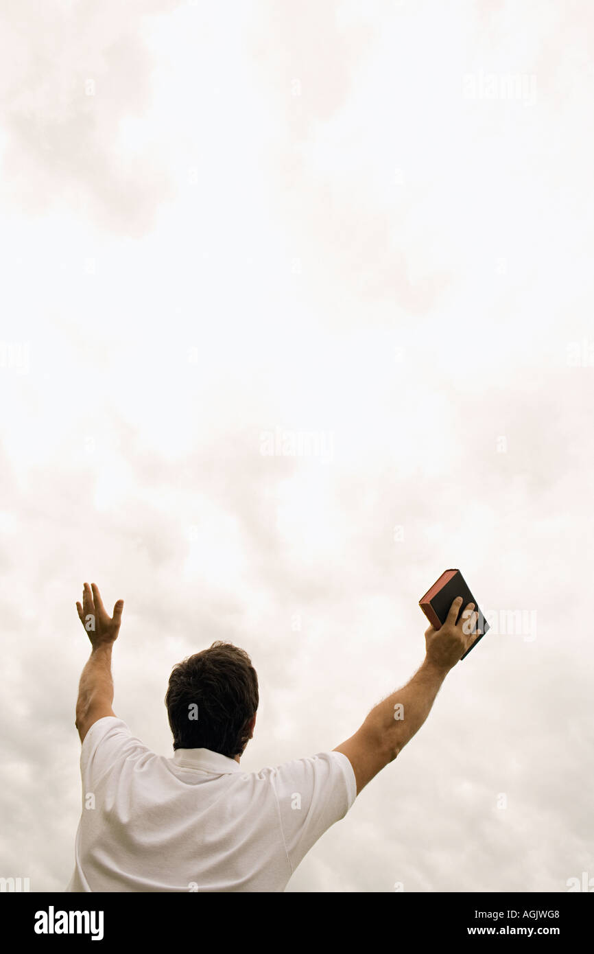 Man worshipping with bible Stock Photo - Alamy