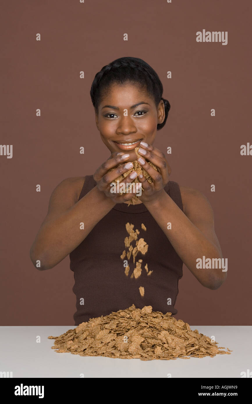 Young woman dropping cereal Stock Photo - Alamy