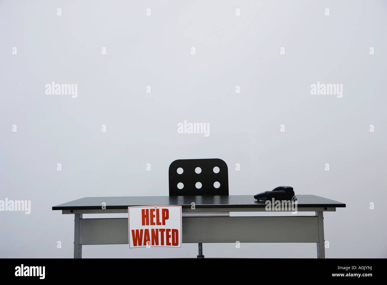 Help wanted sign hanging off a desk Stock Photo - Alamy
