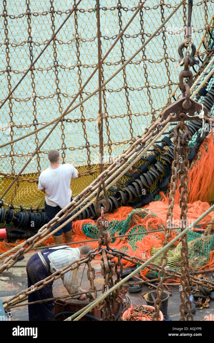 Routine maintenance and sorting the nets on board a trawler moored in ...
