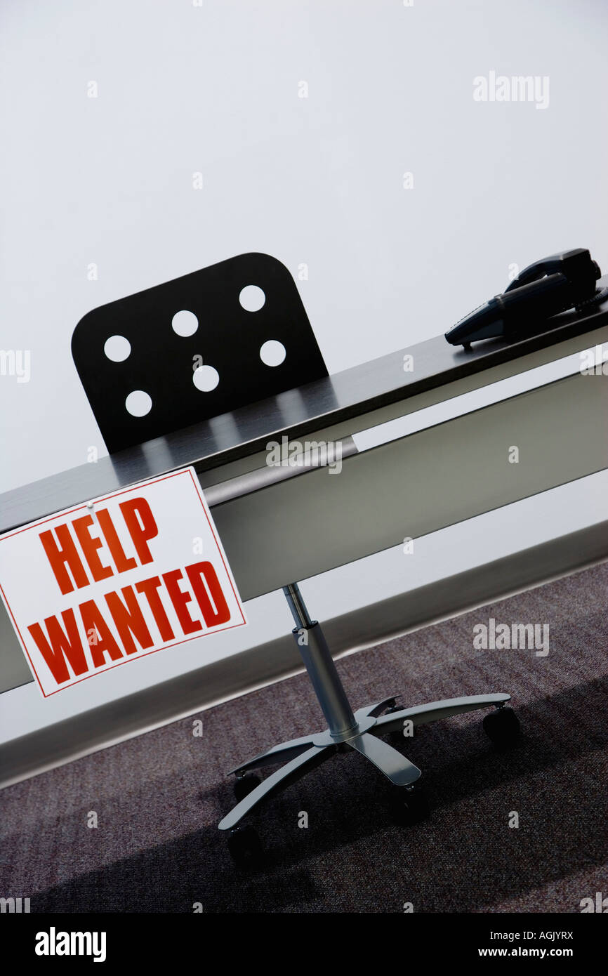 Help wanted sign hanging off a desk Stock Photo - Alamy