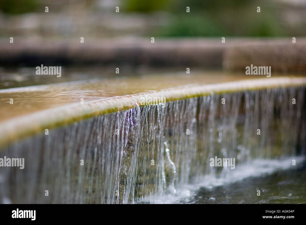 Water trickling over a stone ledge Stock Photo - Alamy