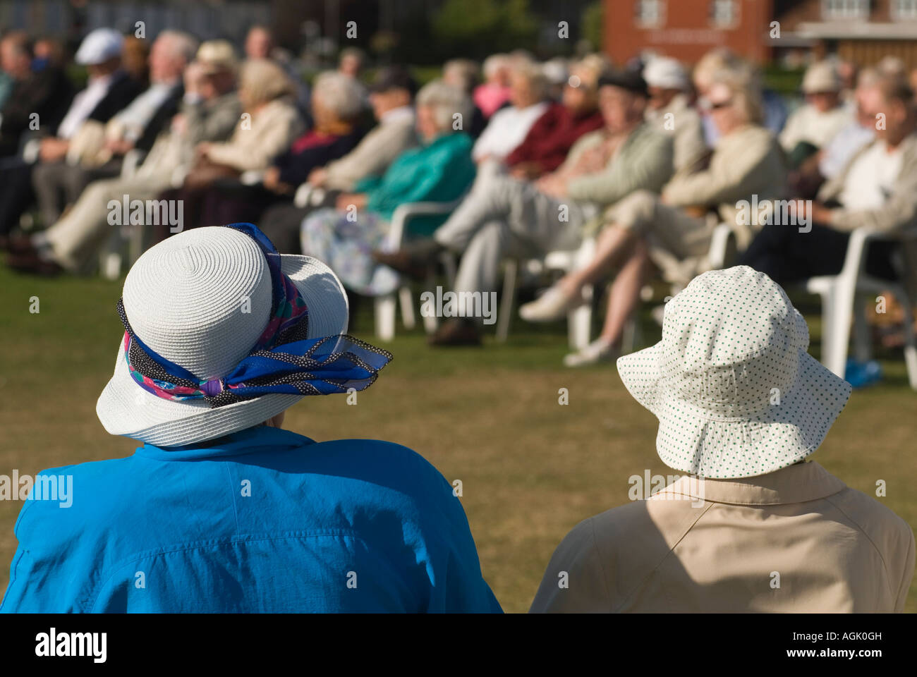 UK older elderly women. Two OAP ladies listening to summer evening open ...