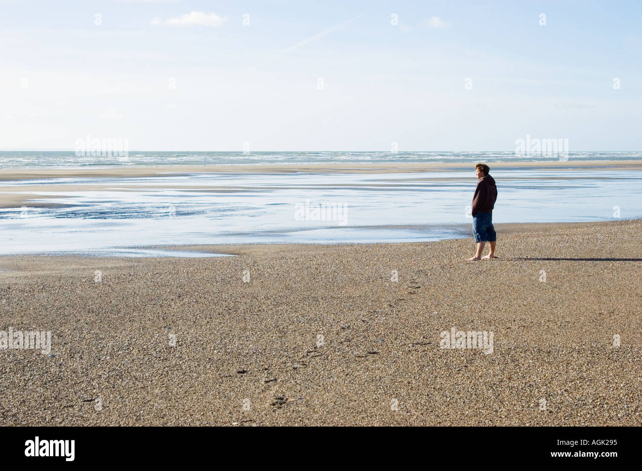 Thoughtful man walking on beach hi-res stock photography and images - Alamy