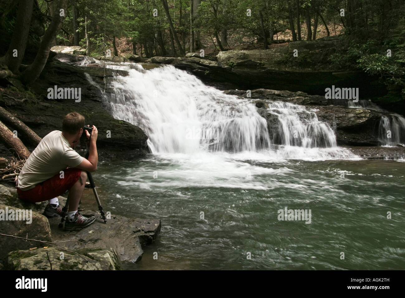 West Virginia USA young man taking a picture of a wild rustic river in ...
