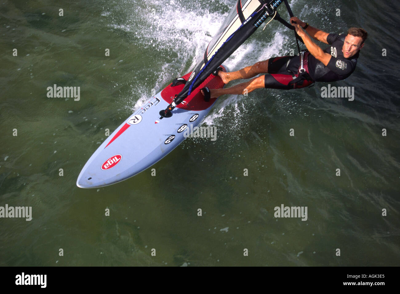 aerial view of male windsurfer sailing looking at viewer Stock Photo ...