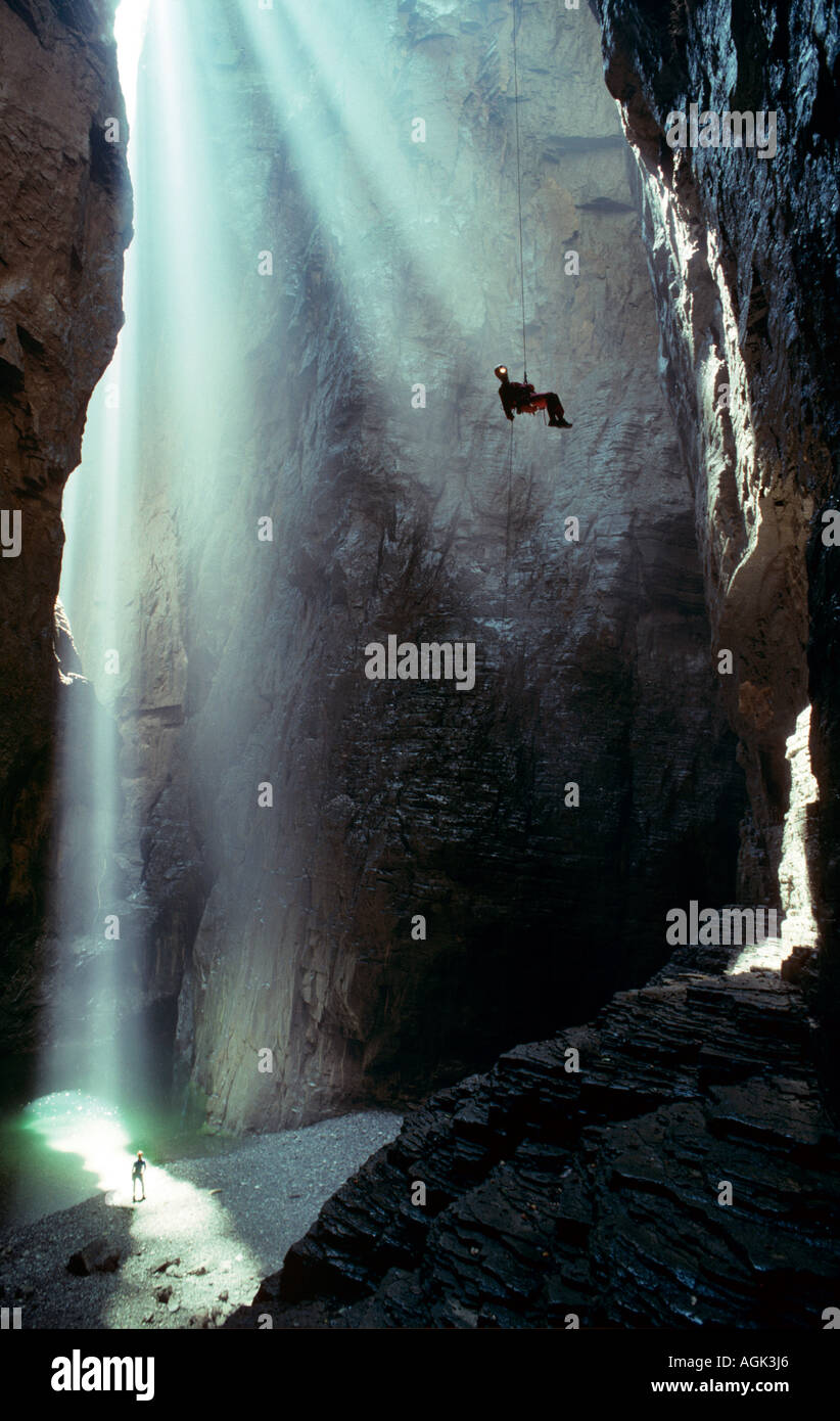 Caver abseiling into deep cave shaft, Sichuan Province, China Stock ...