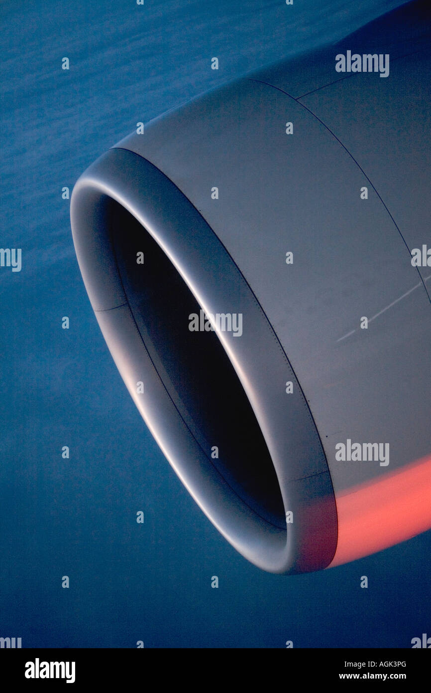 graphic shot of airplane wing and engine taken at sunrise showing pink ...