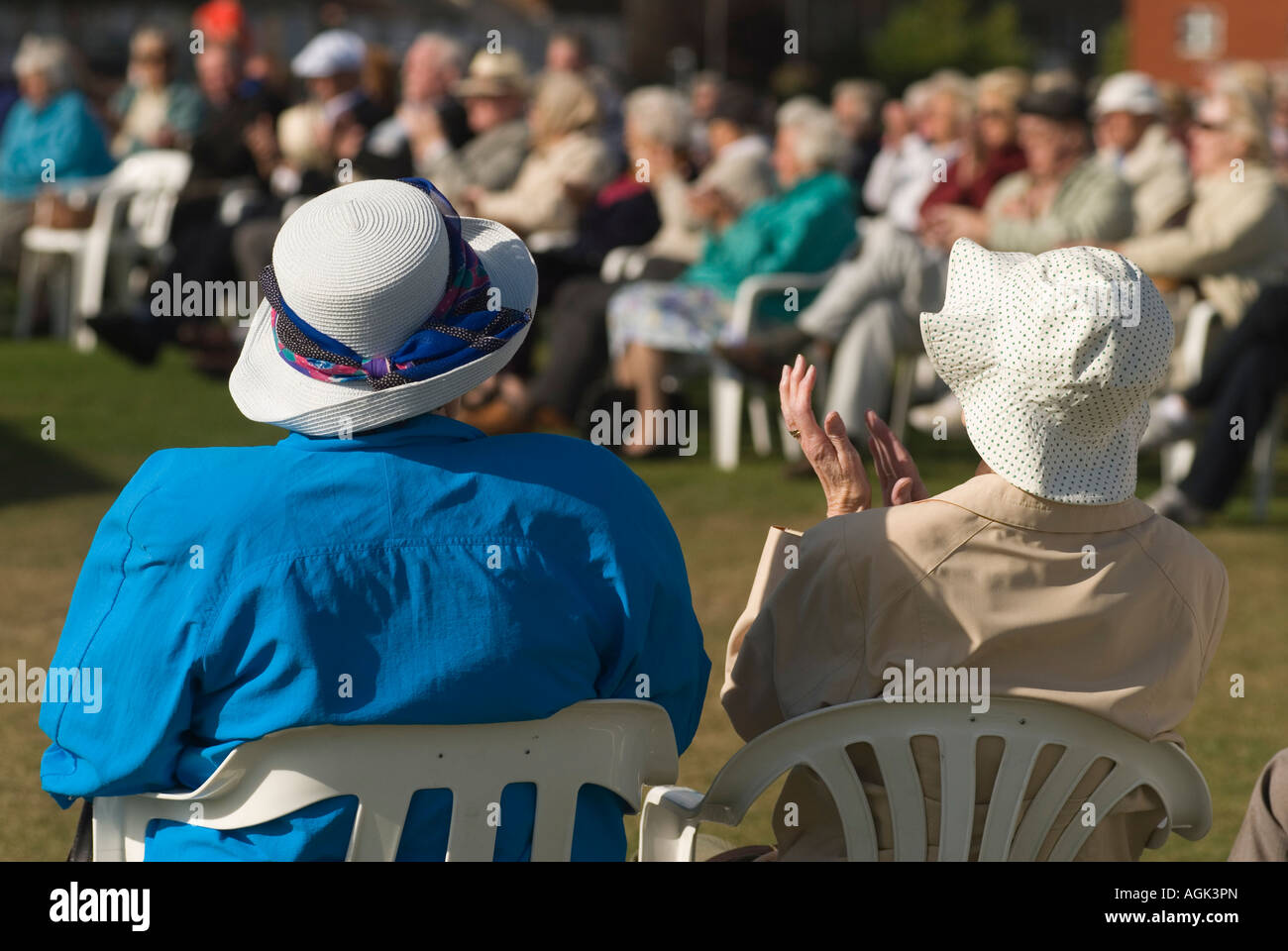 Senior women UK. Oap listening to summer evening open air musical ...