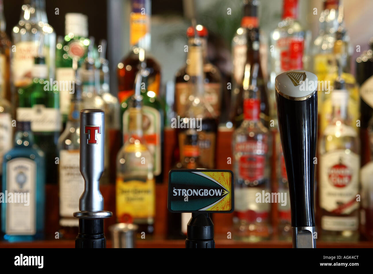 Drinks bottles and beer taps in a bar Stock Photo - Alamy