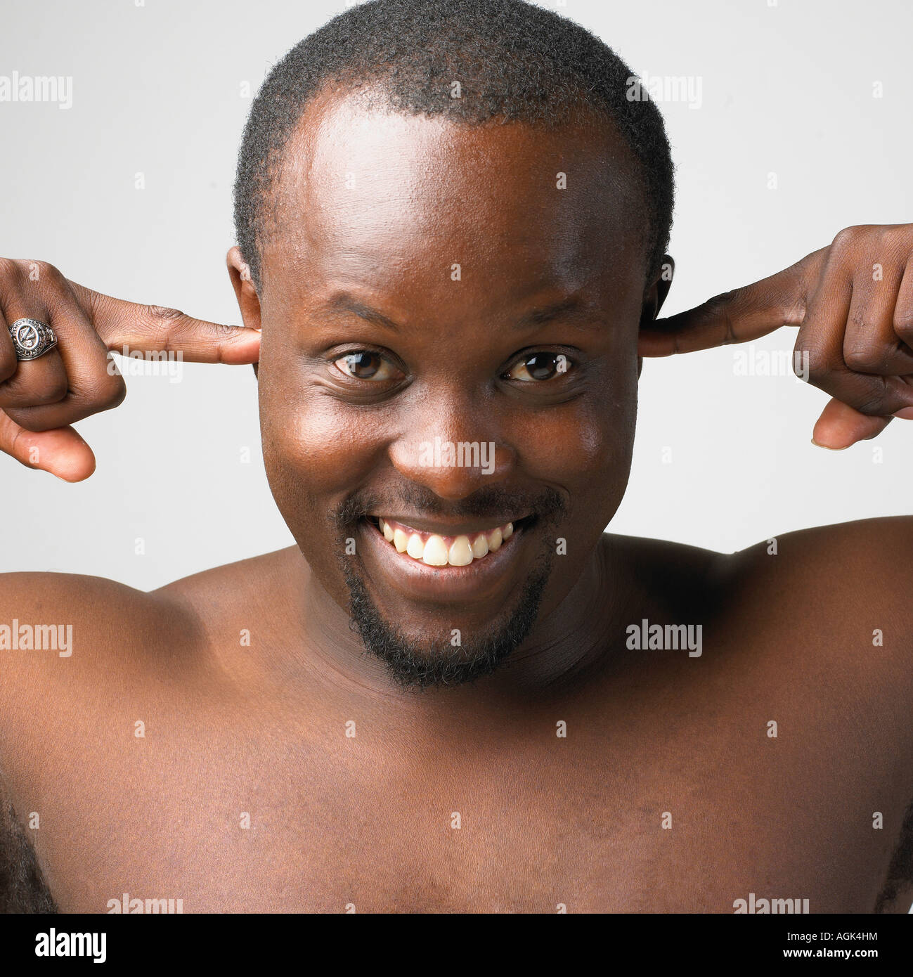 Headshot of afro american man with fingers in ears Stock Photo - Alamy