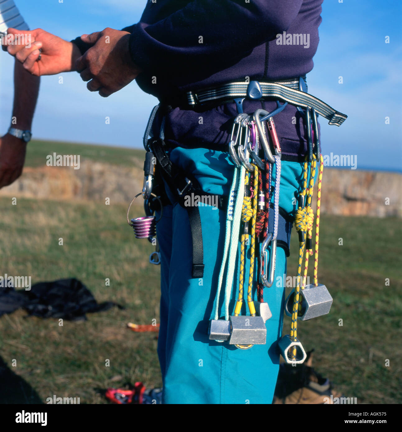 Rock climber with gear dangling from belt at Mowingword Bay Stackpole ...