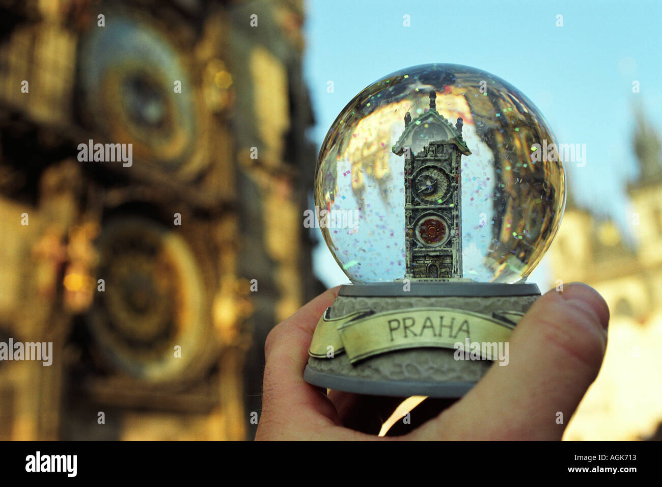 Hand holding Snow shaker in front of astonomical clock in Prague Stock ...