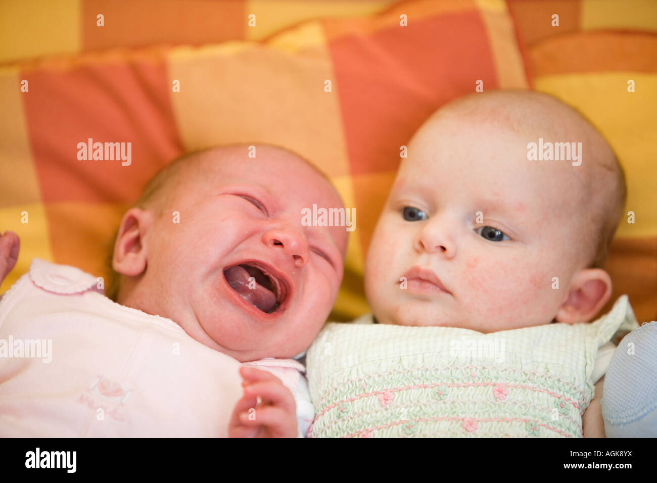two babies, one crying Stock Photo - Alamy