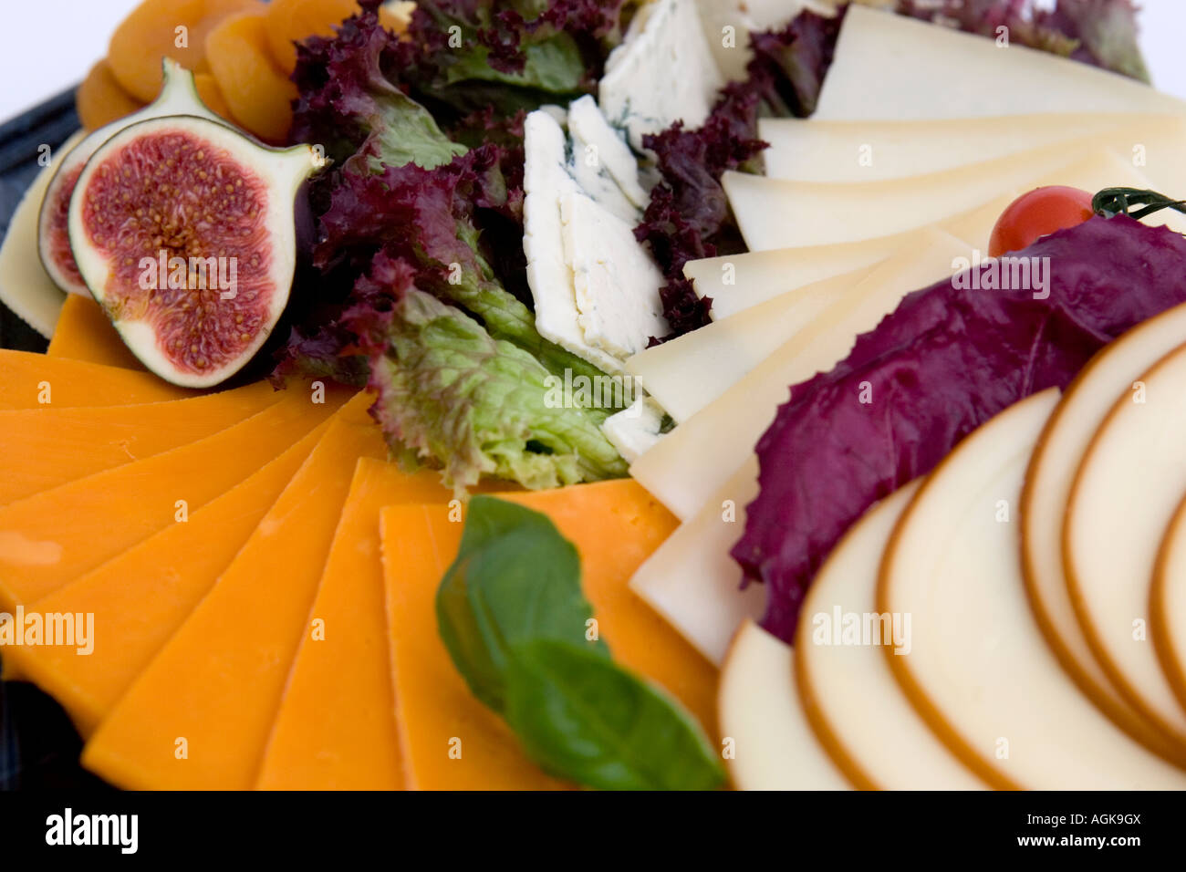 Selection of sliced cheeses on tray Stock Photo - Alamy