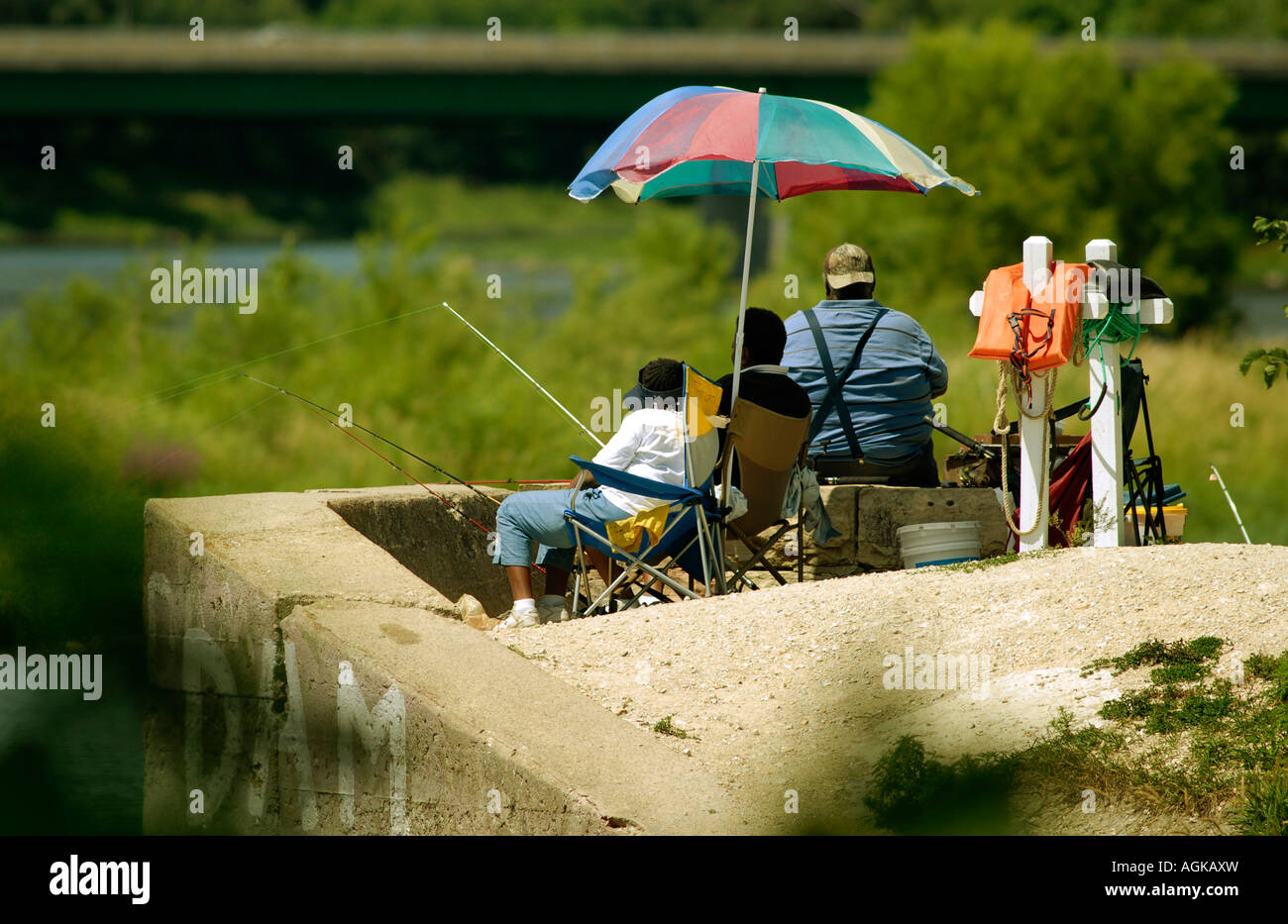 A family fishing at a dam on a river in the U S Stock Photo - Alamy