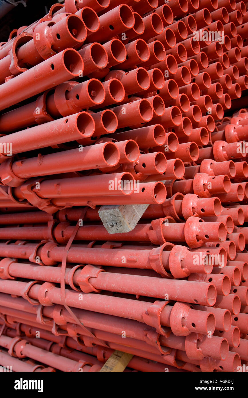 Graphic angle shot of red plastic tubes used in construction on a ...