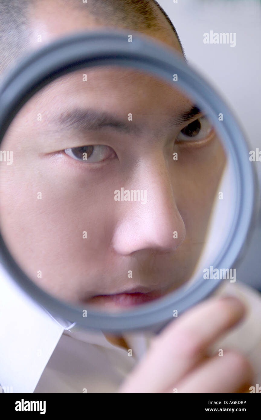 Man Looking Through Magnifying Glass Stock Photo - Alamy
