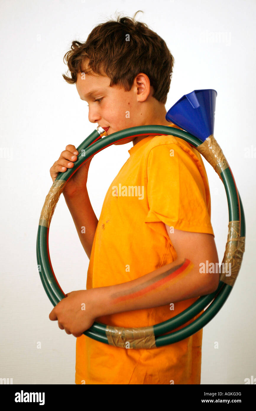 a young boy playing a self made musical instrument Stock Photo - Alamy