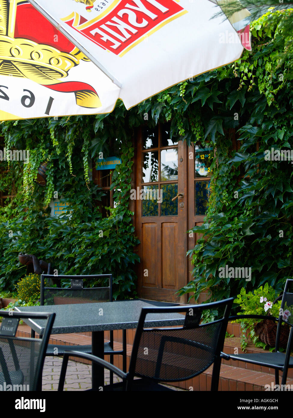 Tables outside of tavern and tavern doorway in a village outside of ...