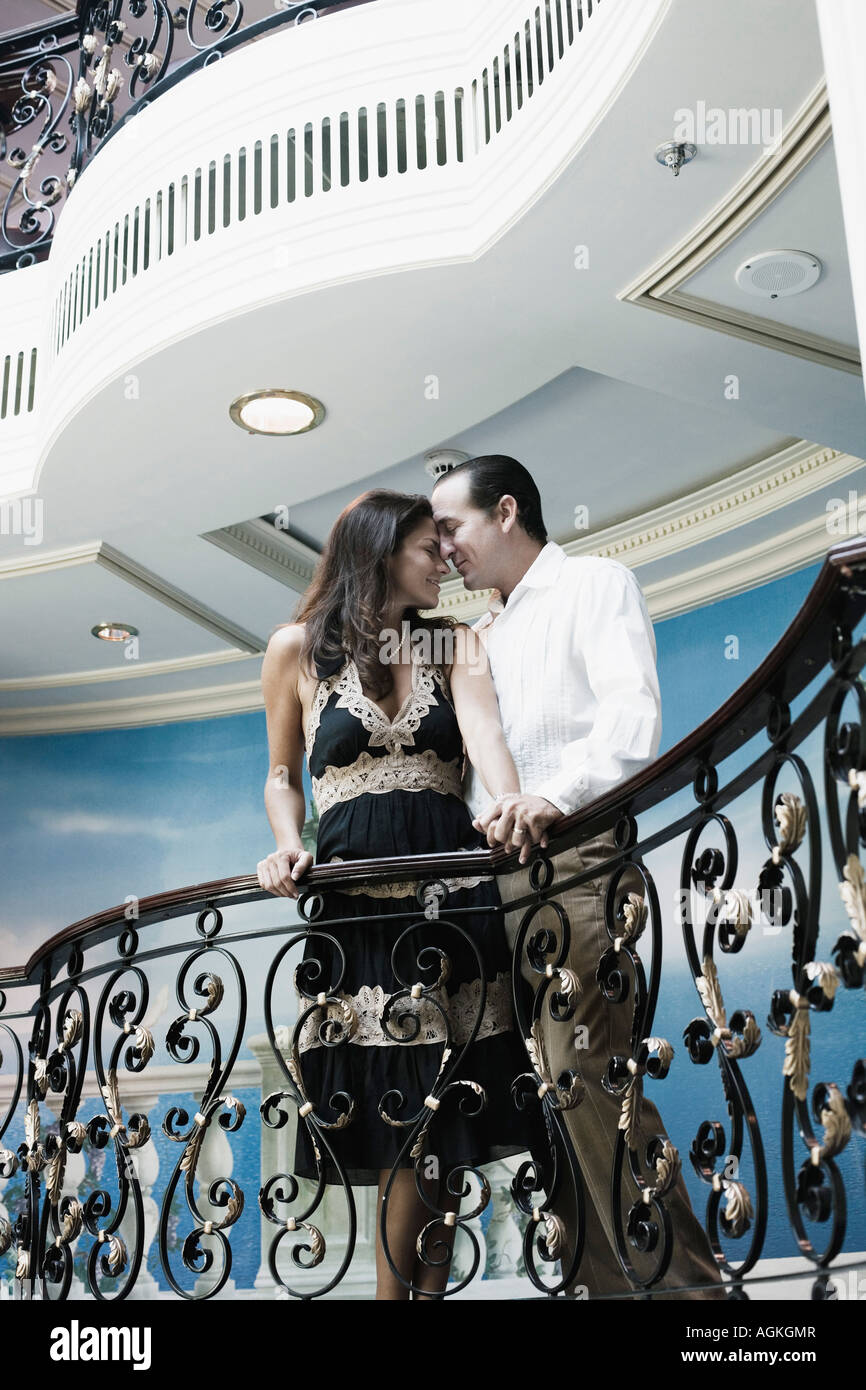 Mid adult couple romancing at a balcony of a ship Stock Photo - Alamy
